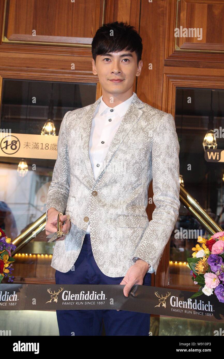 Taiwanese actor Joseph Cheng prepares to cut the ribbon during the ...