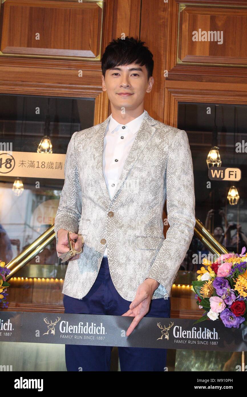 Taiwanese actor Joseph Cheng prepares to cut the ribbon during the ...