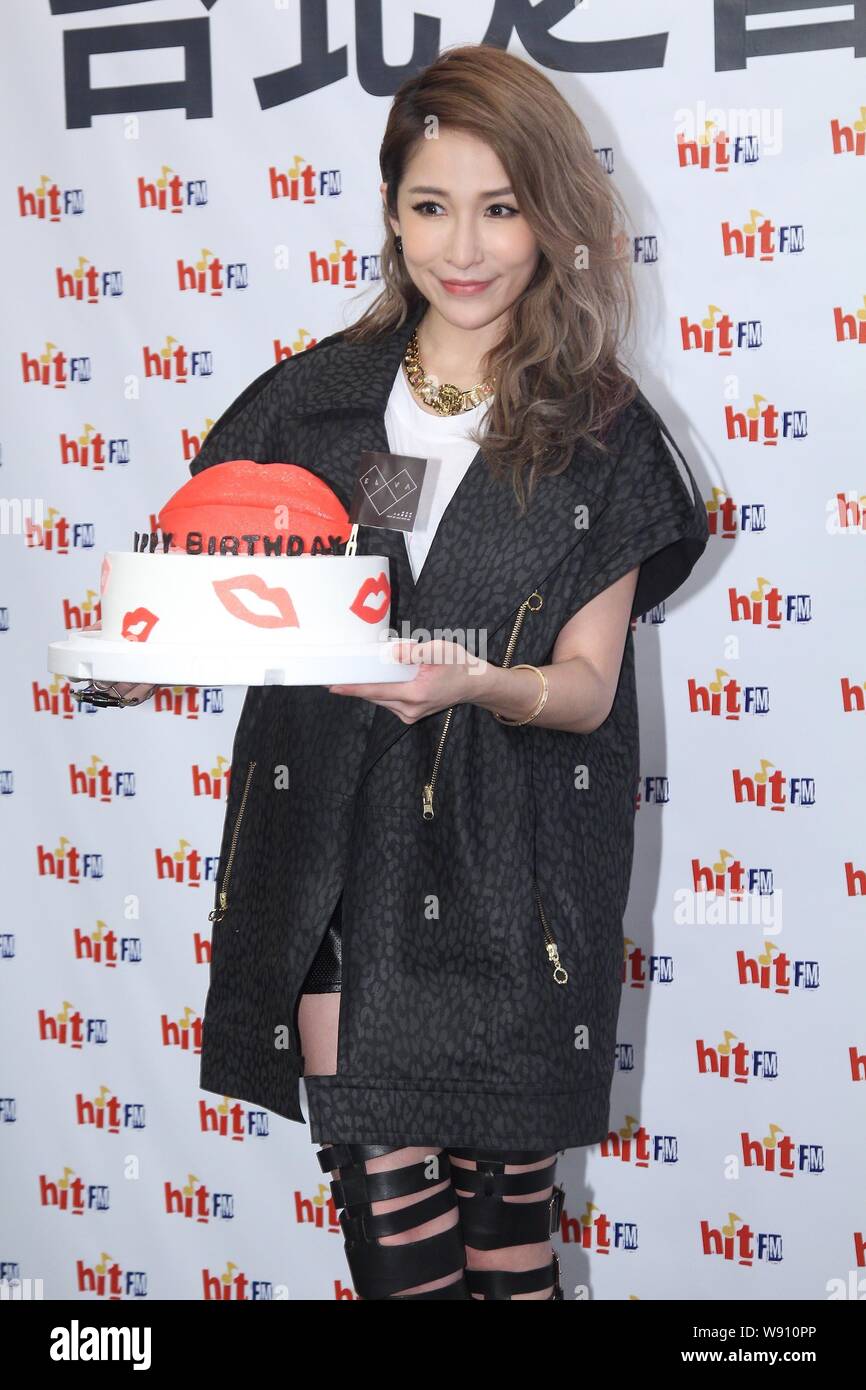 Taiwanese singer Elva Hsiao poses with a birthday cake during an interview at Hit FM radio ...