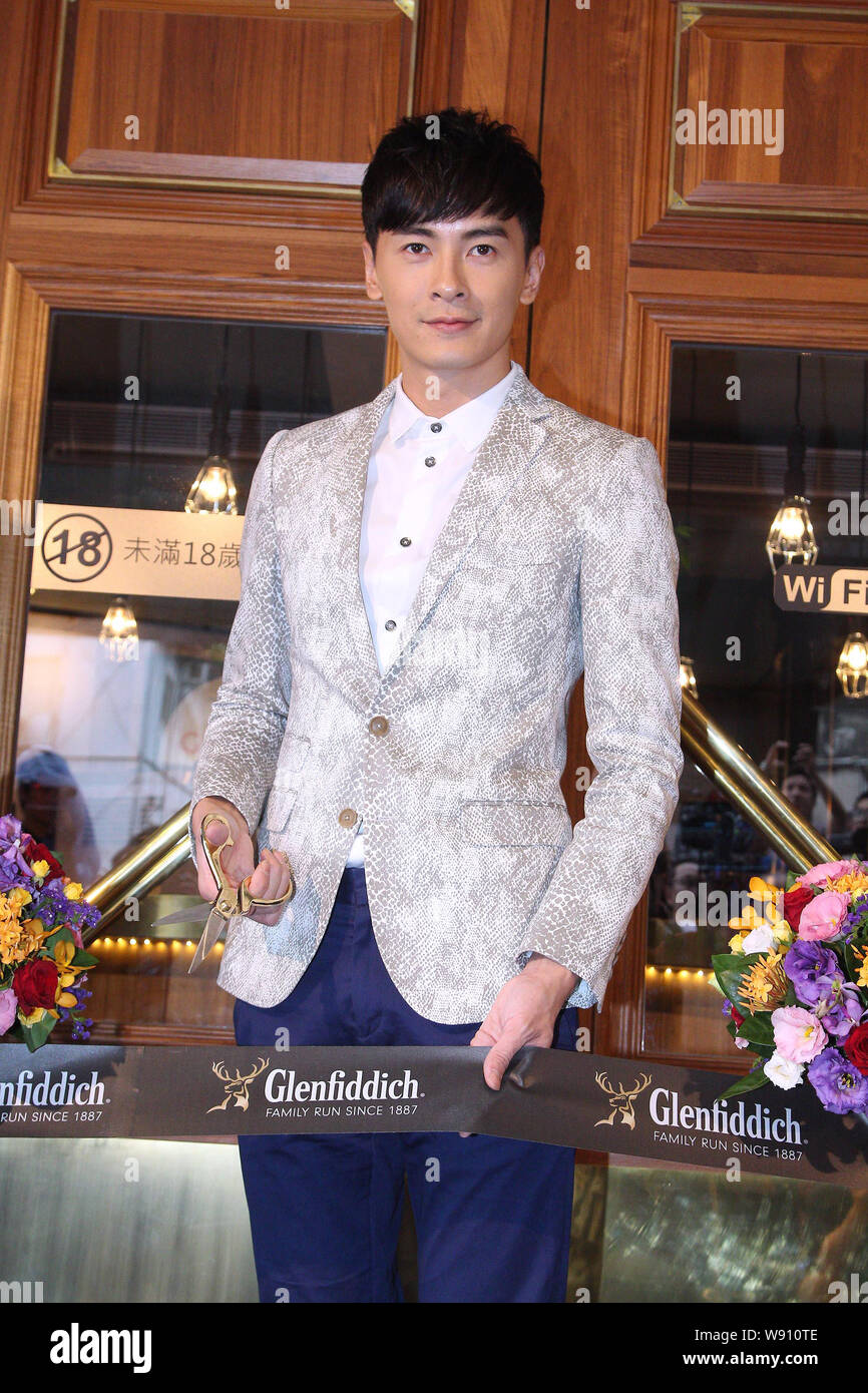 Taiwanese actor Joseph Cheng prepares to cut the ribbon during the ...