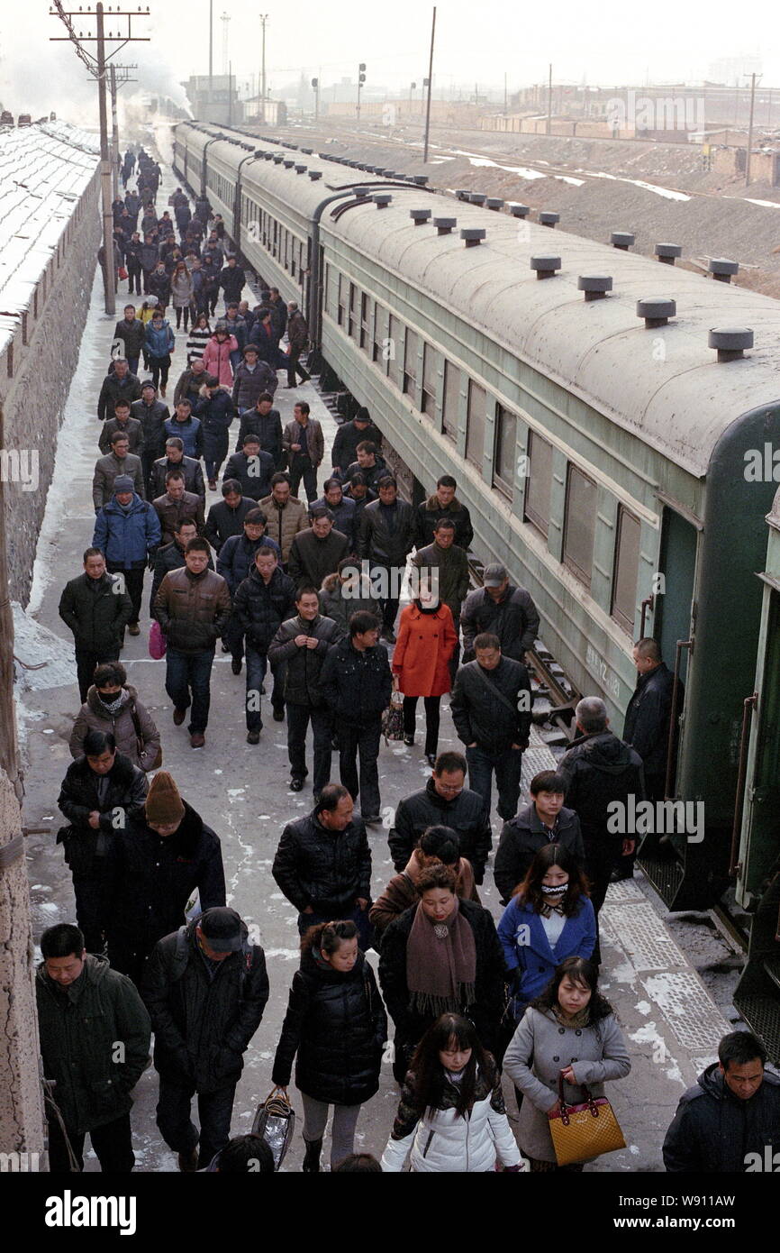 --FILE--Passengers walk along the platform towards the exit after ...