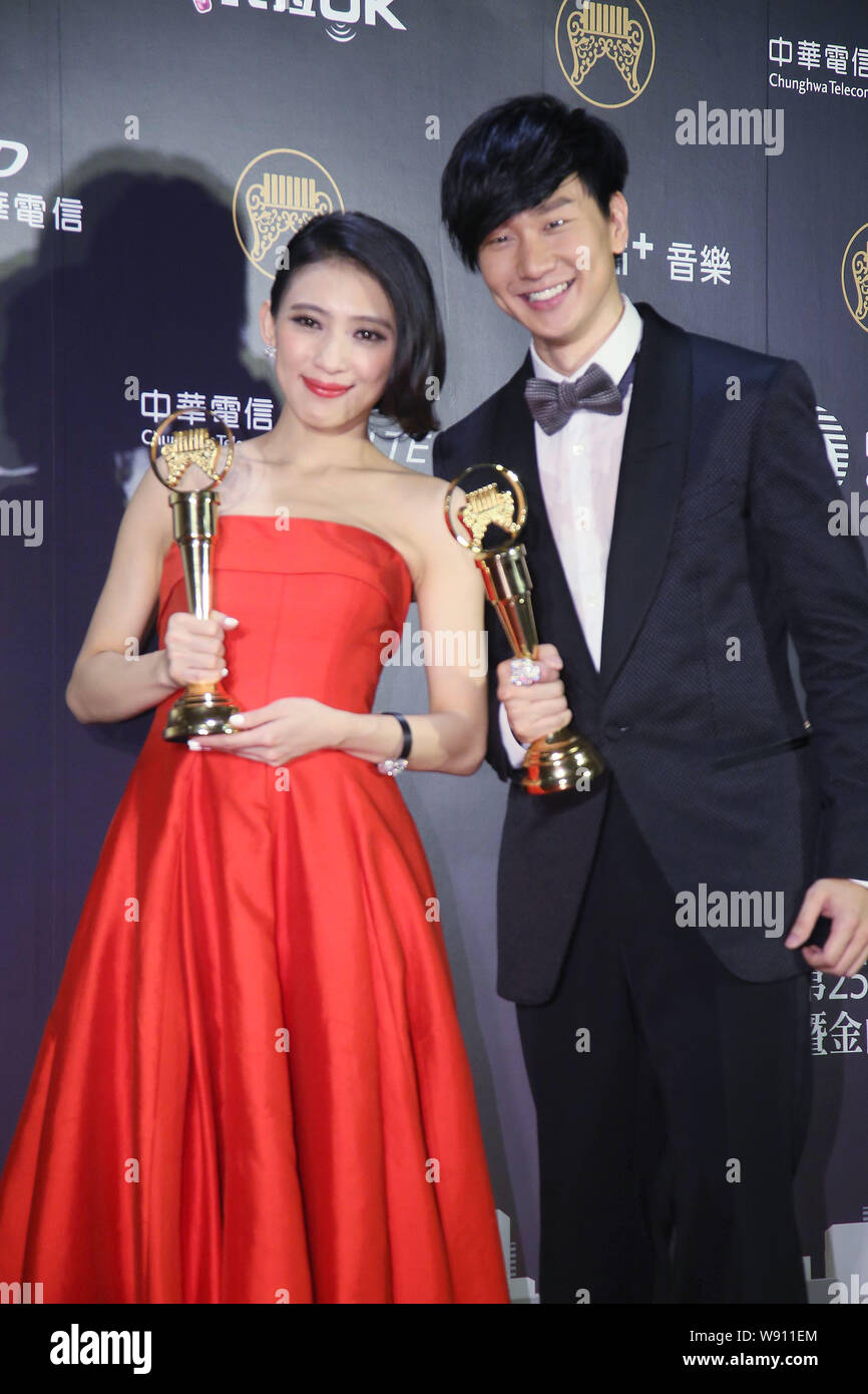 Malaysian singer Penny Tai, left, and Singapore singer JJ Lin hold up ...