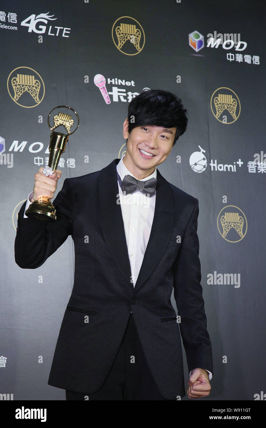 Singaporean singer JJ Lin holds up his trophy for Best male Mandarin ...