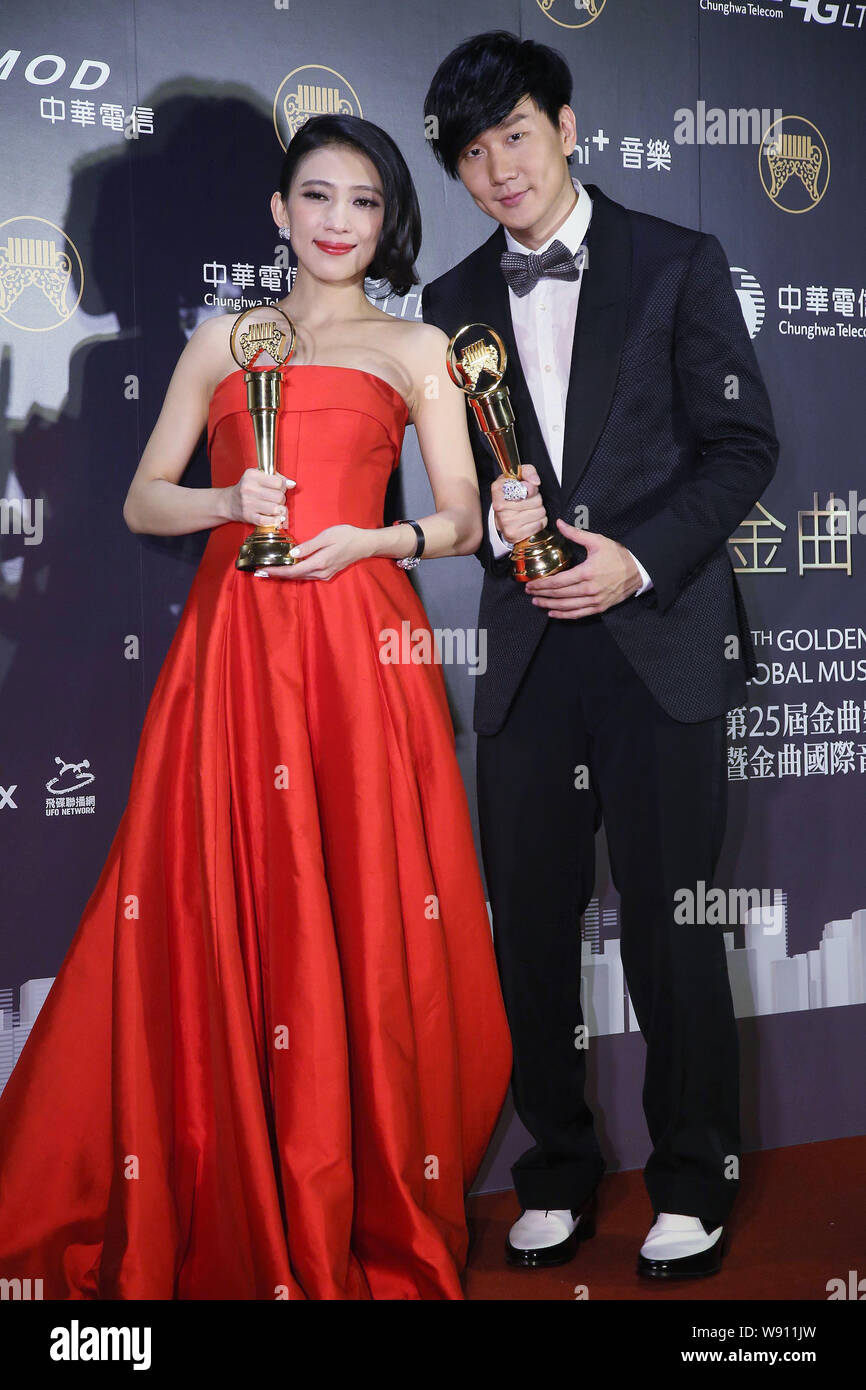 Malaysian singer Penny Tai, left, and Singapore singer JJ Lin hold up ...