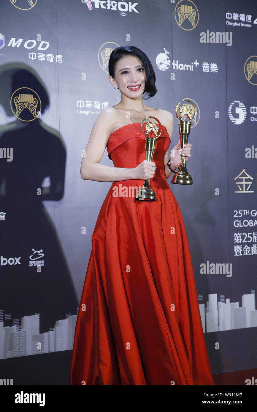 Malaysian singer Penny Tai holds up her trophies for Best Mandarin ...