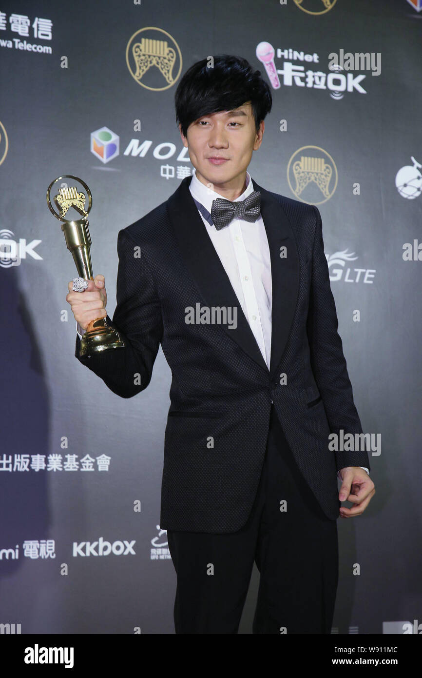 Singaporean singer JJ Lin holds up his trophy for Best male Mandarin ...