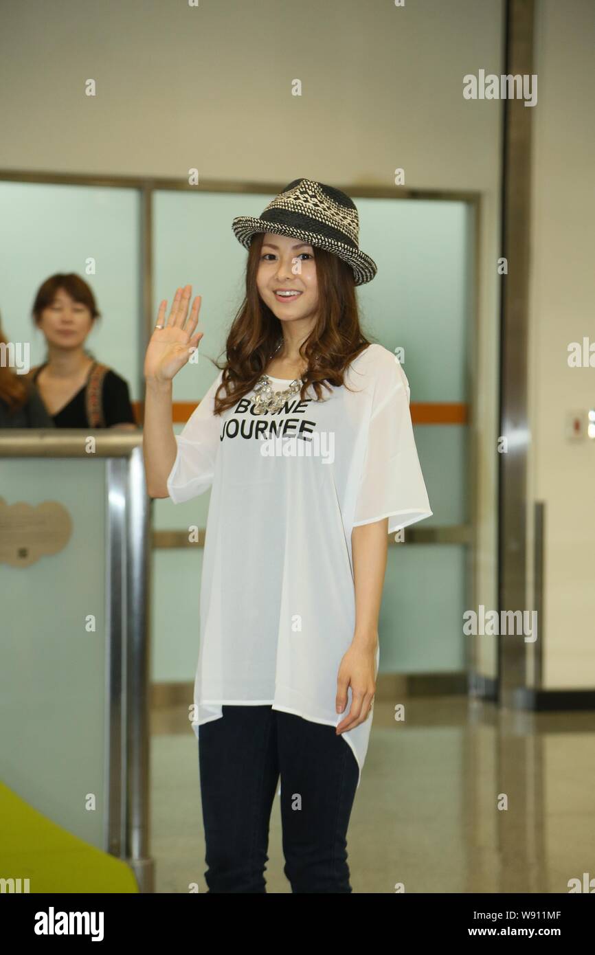 Japanese singer Mai Kuraki waves after arriving at an airport in Taipei ...