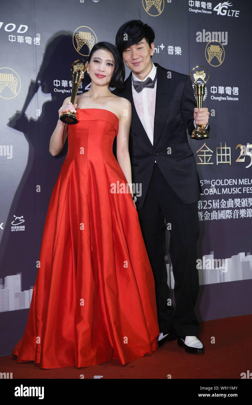 Malaysian singer Penny Tai, left, and Singapore singer JJ Lin hold up ...