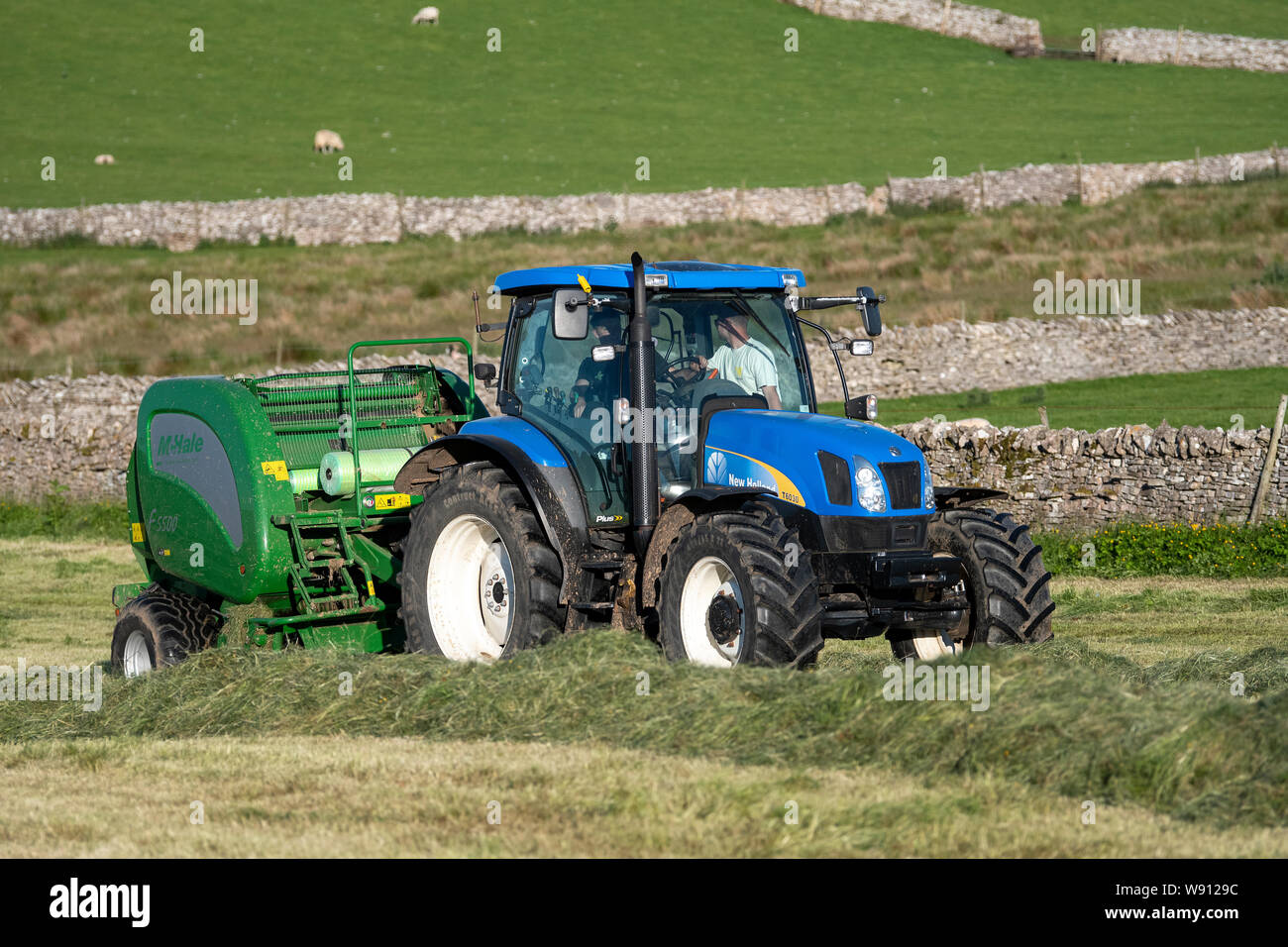 Making haylage crop on a hill farm, with a New Holland T6030 and a ...