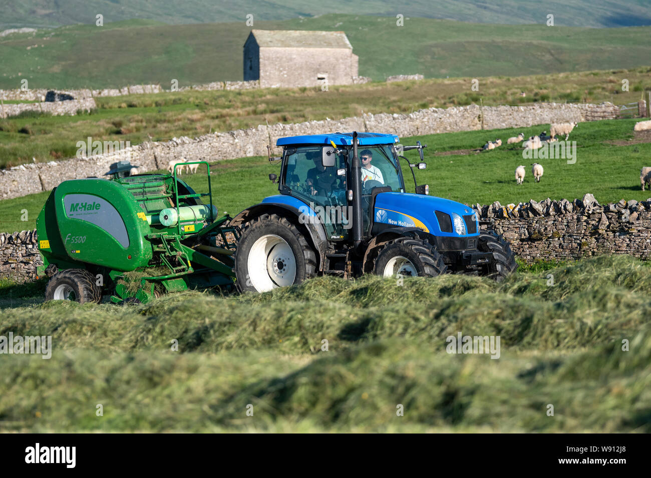 Making haylage crop on a hill farm, with a New Holland T6030 and a ...