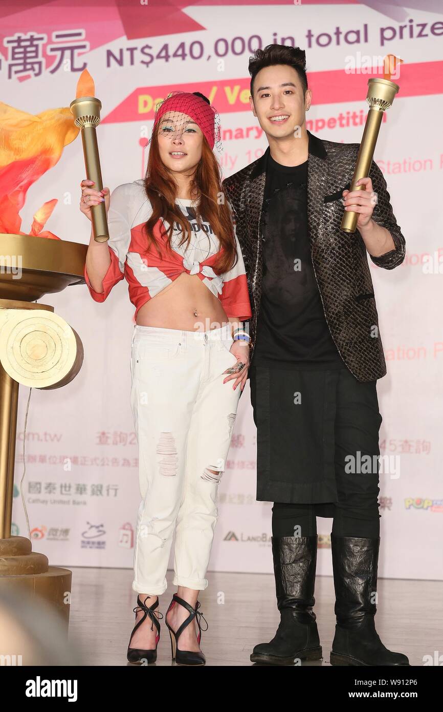 Taiwanese singers Landy Wen, left, and Wilber Pan pose with fake ...