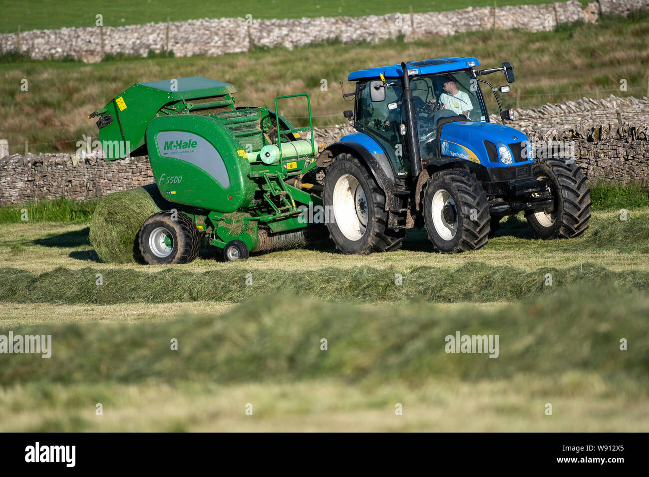 Making haylage crop on a hill farm, with a New Holland T6030 and a ...