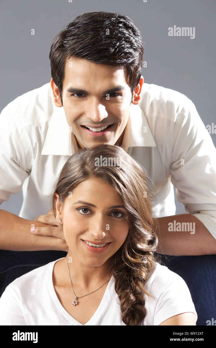 Young couple smiling together Stock Photo - Alamy