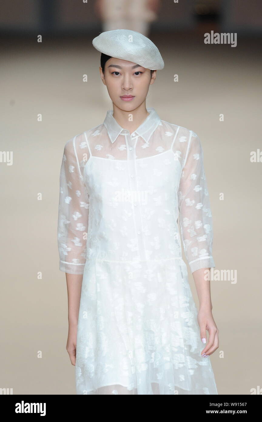 A model displays a new creation by designer Zhao Huizhou at the HUI ...