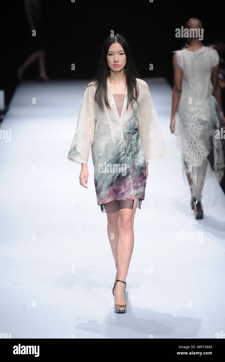A model displays a new creation by designer Li Wei at the Xiuniang Li ...