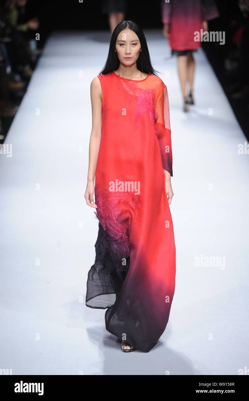 A model displays a new creation by designer Li Wei at the Xiuniang Li ...