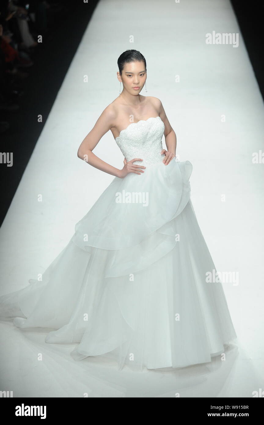 A model displays a new creation by designer Wei Xinkun at the Aolisha ...