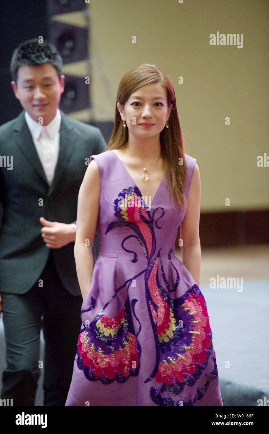 Chinese actress Zhao Wei, front, poses in front of actor Tong Dawei at ...