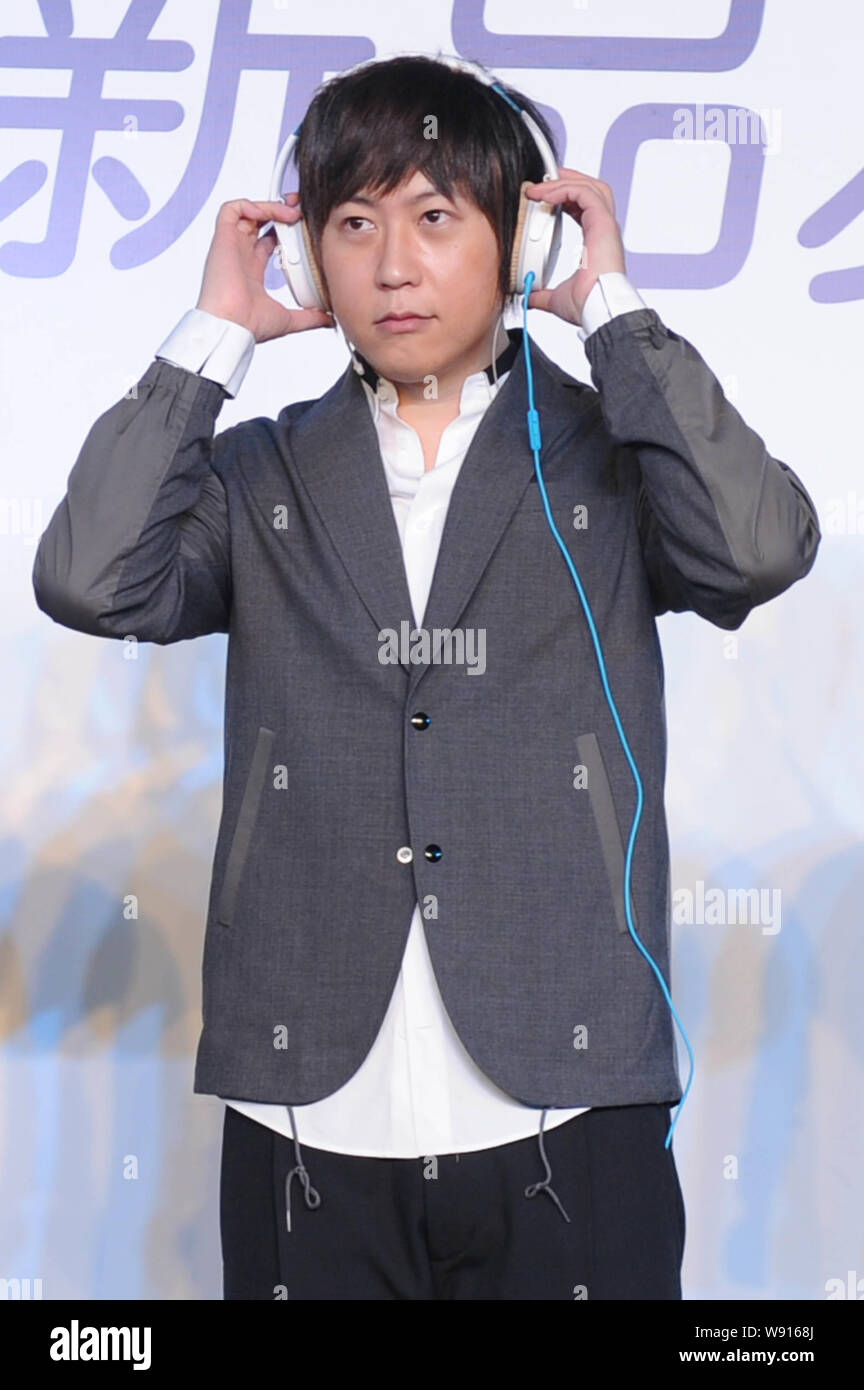 Ashin (Chen Hsin-hung) of Taiwanese band Mayday puts on a headphone at ...