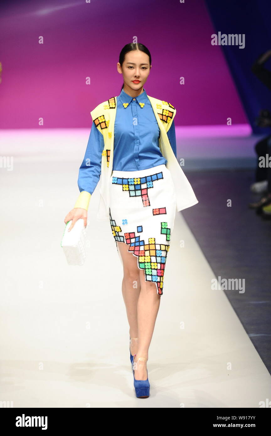 A model displays a creation at the W.S.M 2014 China Knitwear Fashion ...