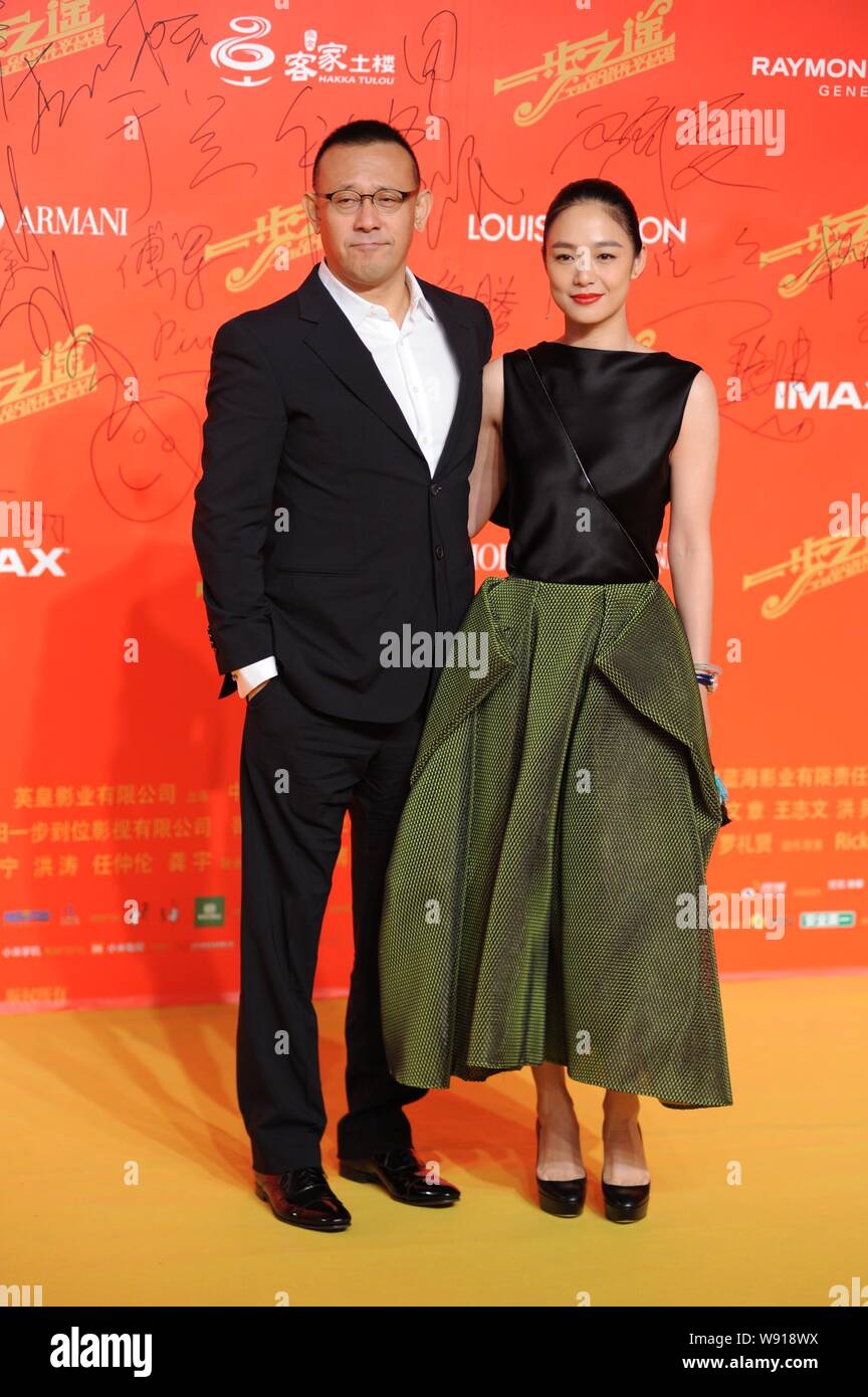 Chinese director and actor Jiang Wen, left, poses with his actress wife ...