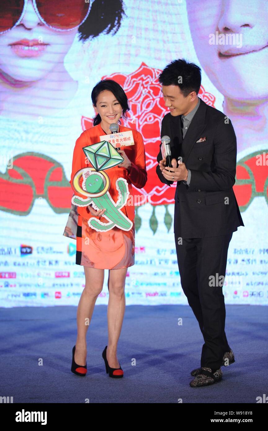 Chinese actress Zhou Xun, left, and actor Tong Dawei smile during a ...