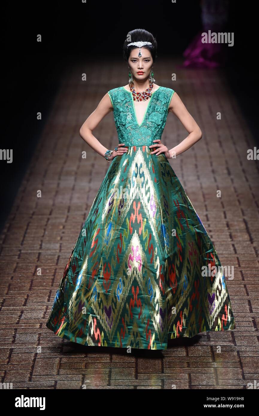 A model displays a new creation by designer Cheng Yingfen at the ...