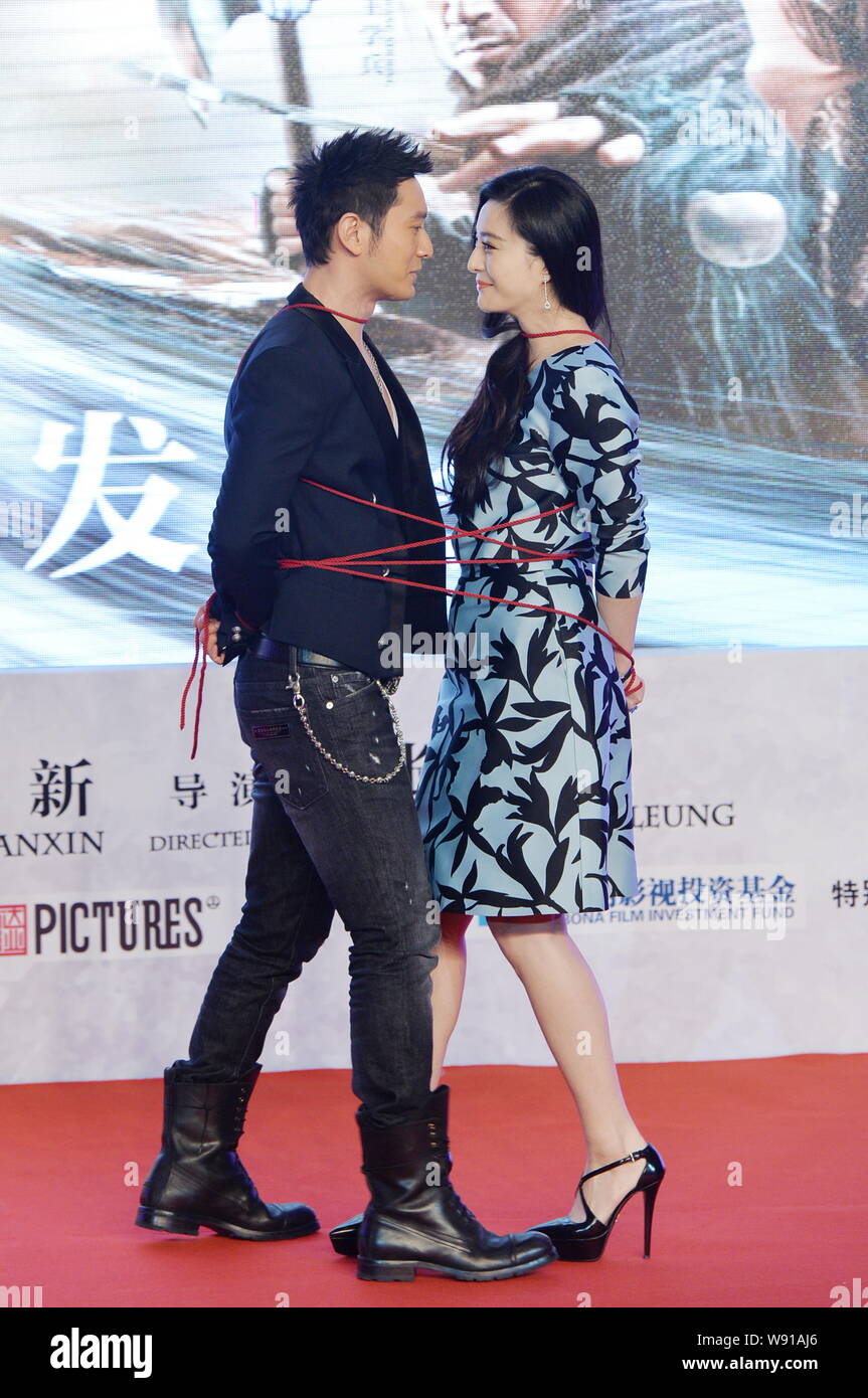 Chinese actor Huang Xiaoming, left, and actress Fan Bingbing look into ...