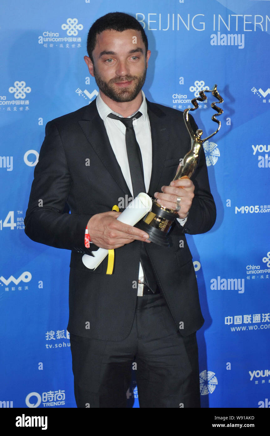 French actor Guillaume Gouix poses with his trophy of the Best Actor ...