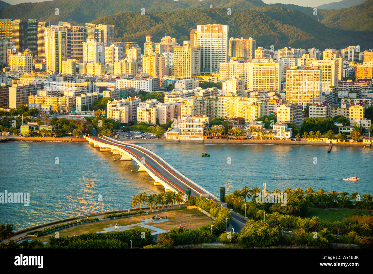 Sanya town evening cityscape, view from Phoenix island on Hainan Island ...