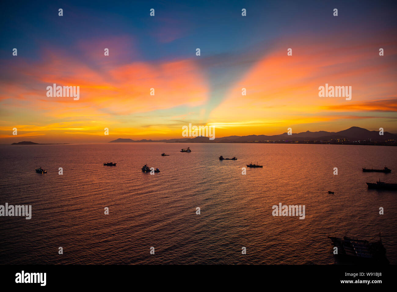 Fishing boats on sea in sunset lights in Sanya, Hainan, China Stock ...