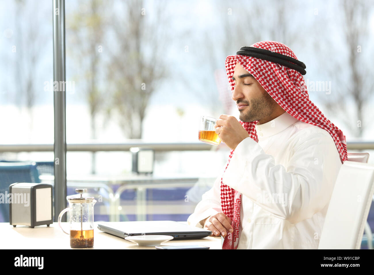 Profile of a relaxed arab man smelling tea in a coffee shop Stock Photo ...