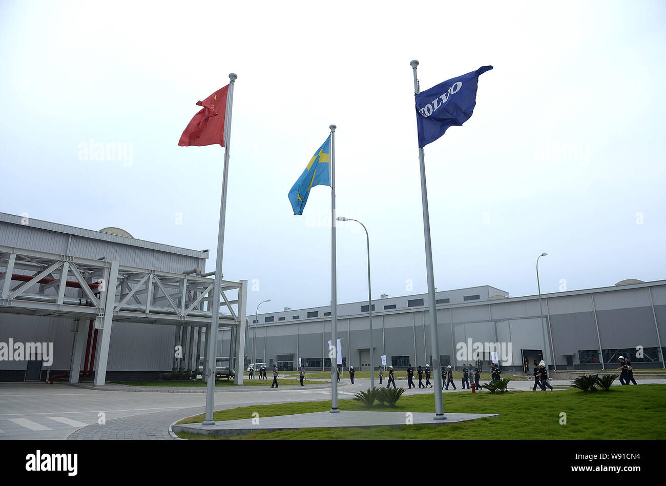 Chinese workers walk at the plant of Volvo in Chengdu city, southwest ...