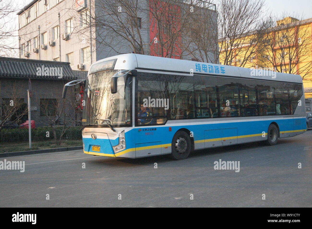 An electric bus travels on a road in Beijing, China, 26 December 2012 ...