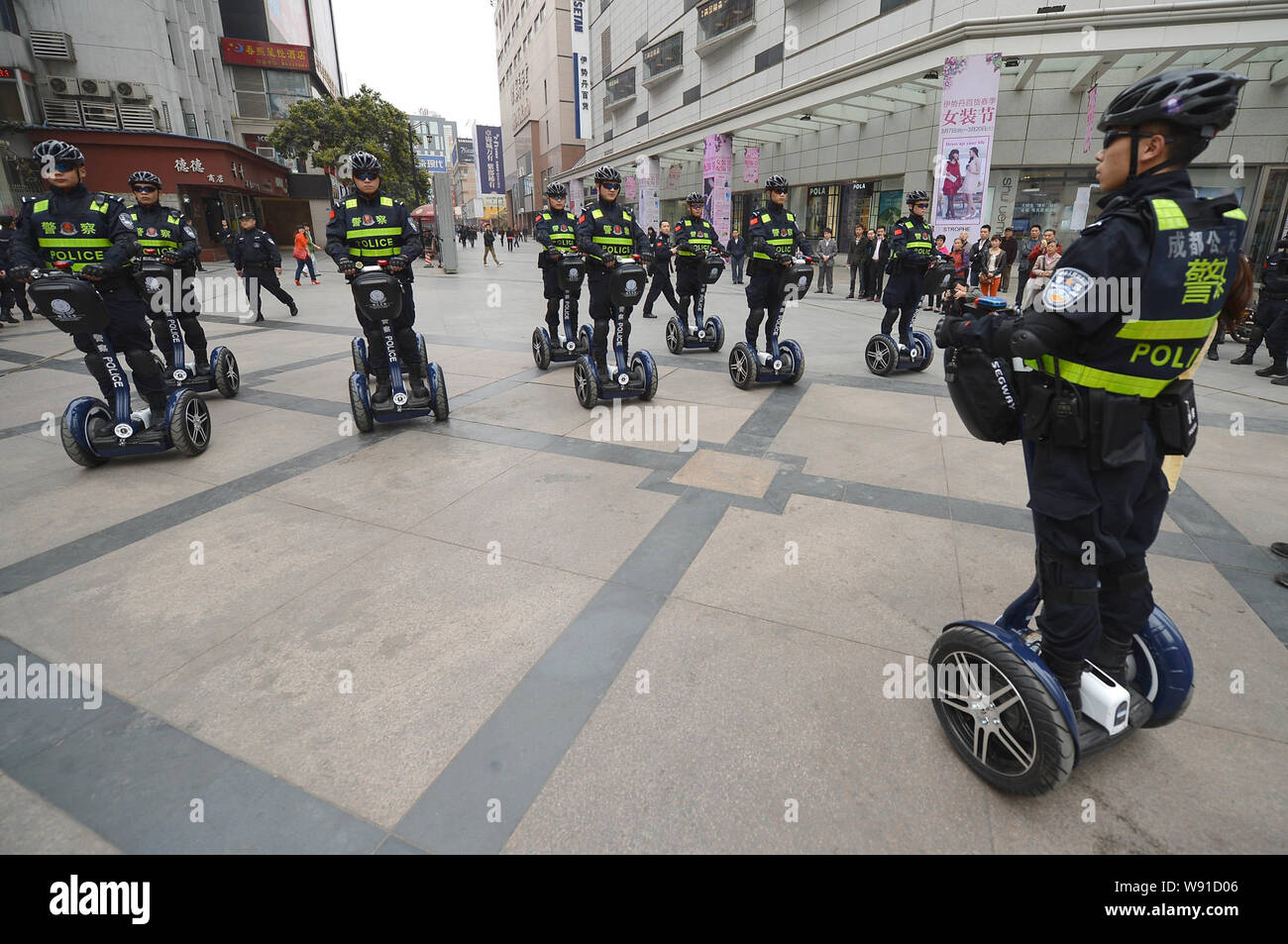 Chinese police officers ride Segway-like two-wheeled electric vehicles ...