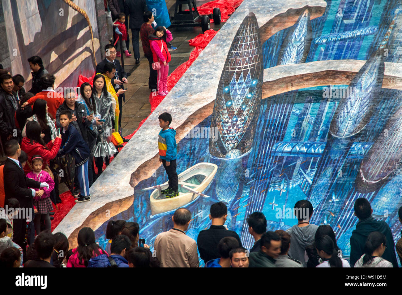 A young visitor poses on the 200-meter long, 6.1-meter wide 3D painting ...