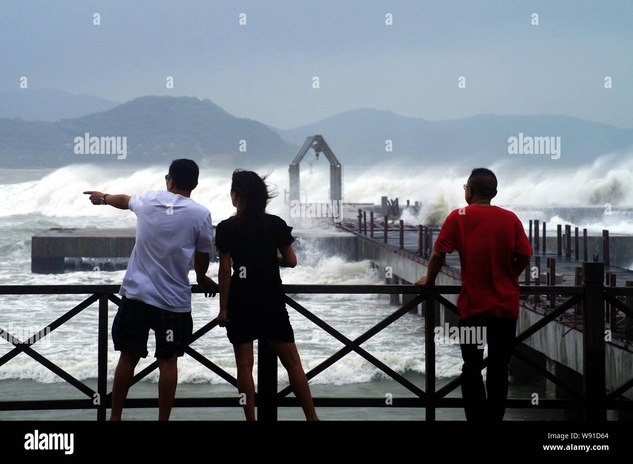 Local Chinese residents look at huge waves caused by approaching ...