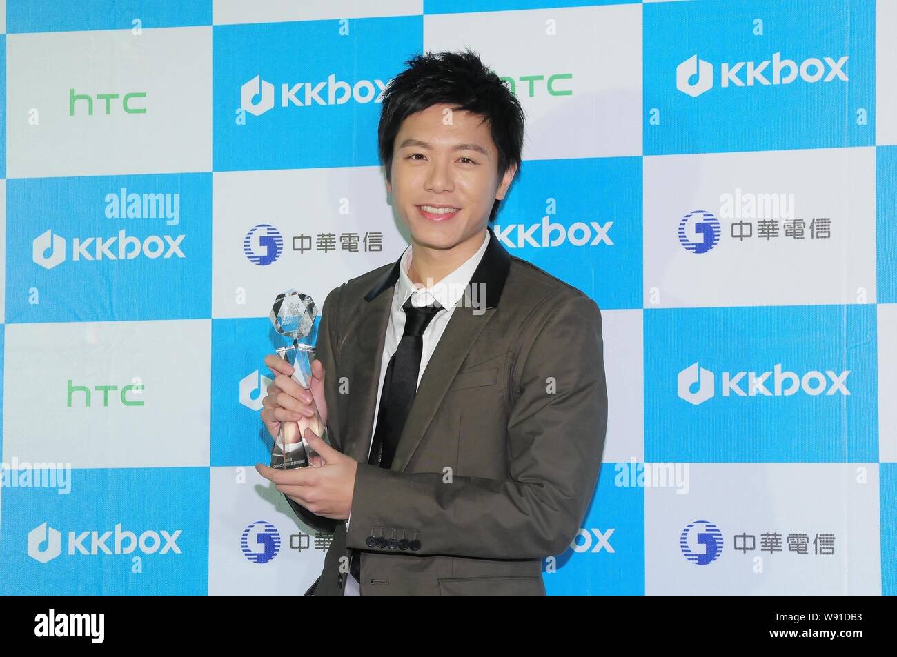 Taiwanese singer William Wei shows his trophy during the 8th KKBOX ...