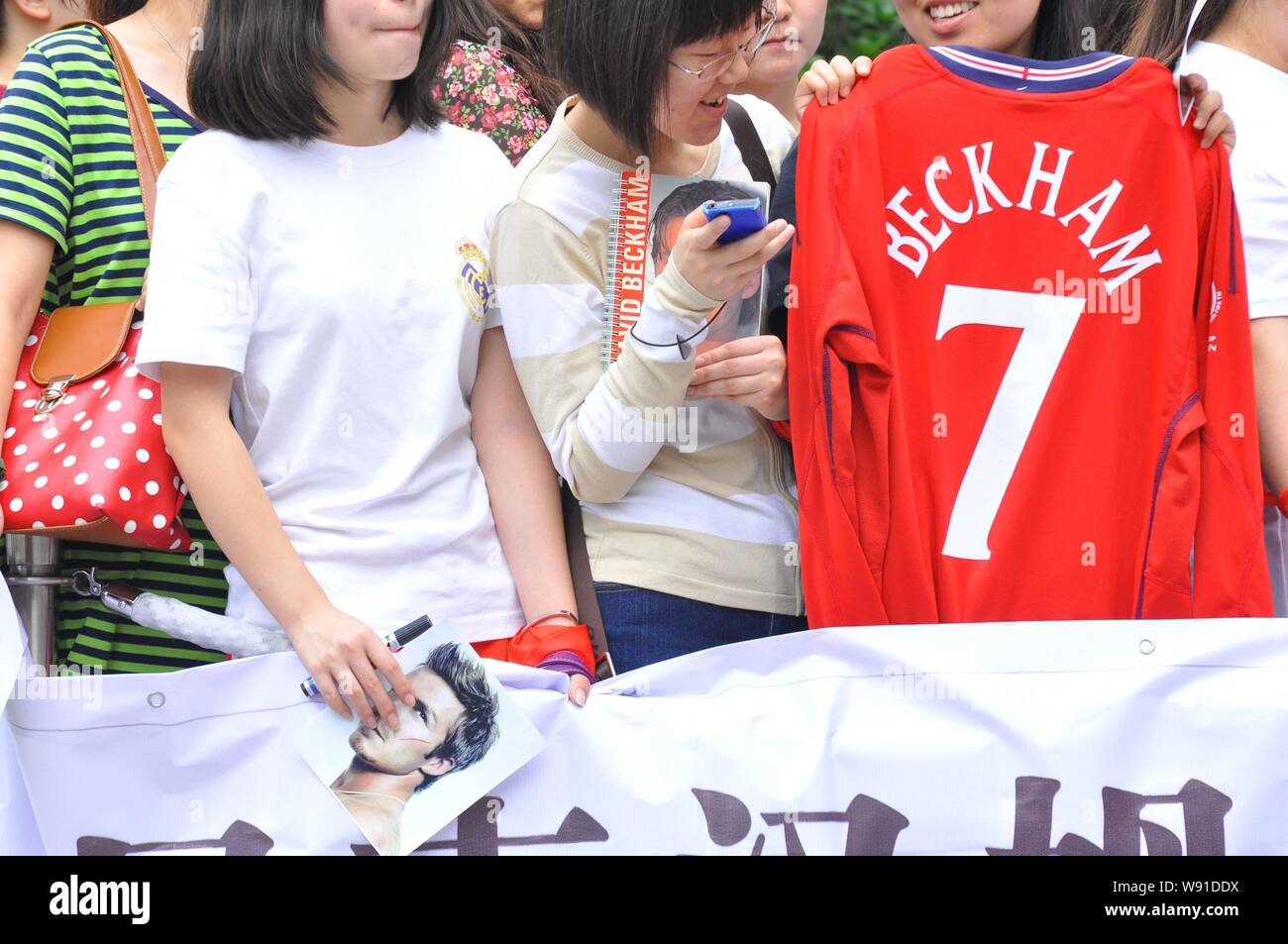 Chinese fans wait at a hotel to welcome English football superstar ...