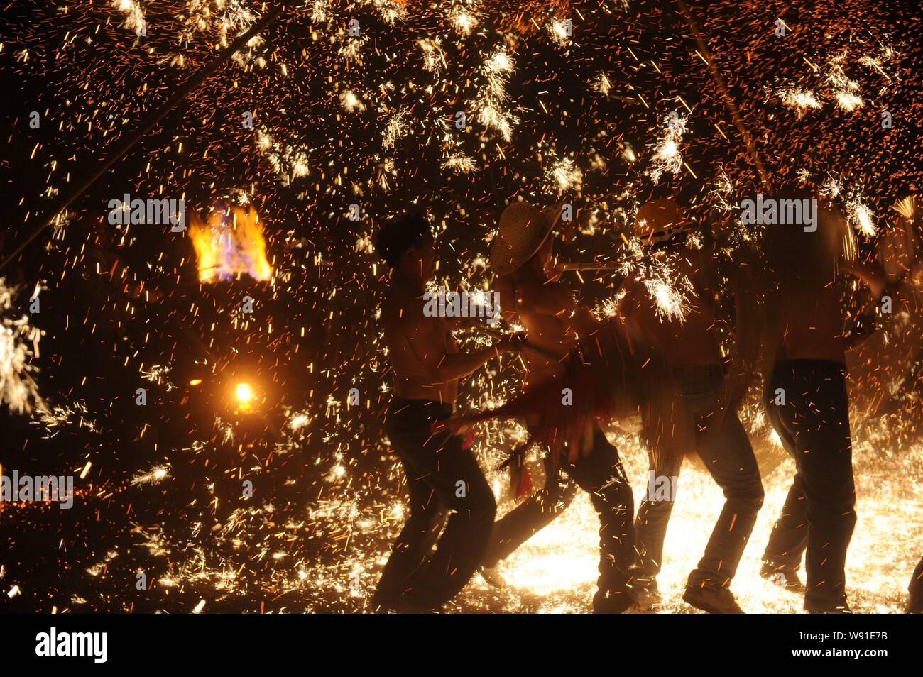 Dancers perform a fire dragon dance in a shower of molten iron to ...
