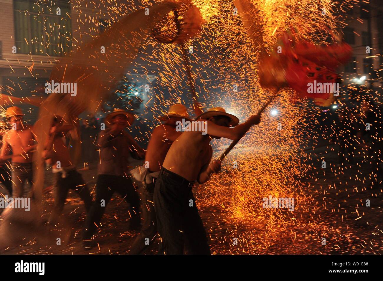 Dancers perform a fire dragon dance in a shower of molten iron to ...