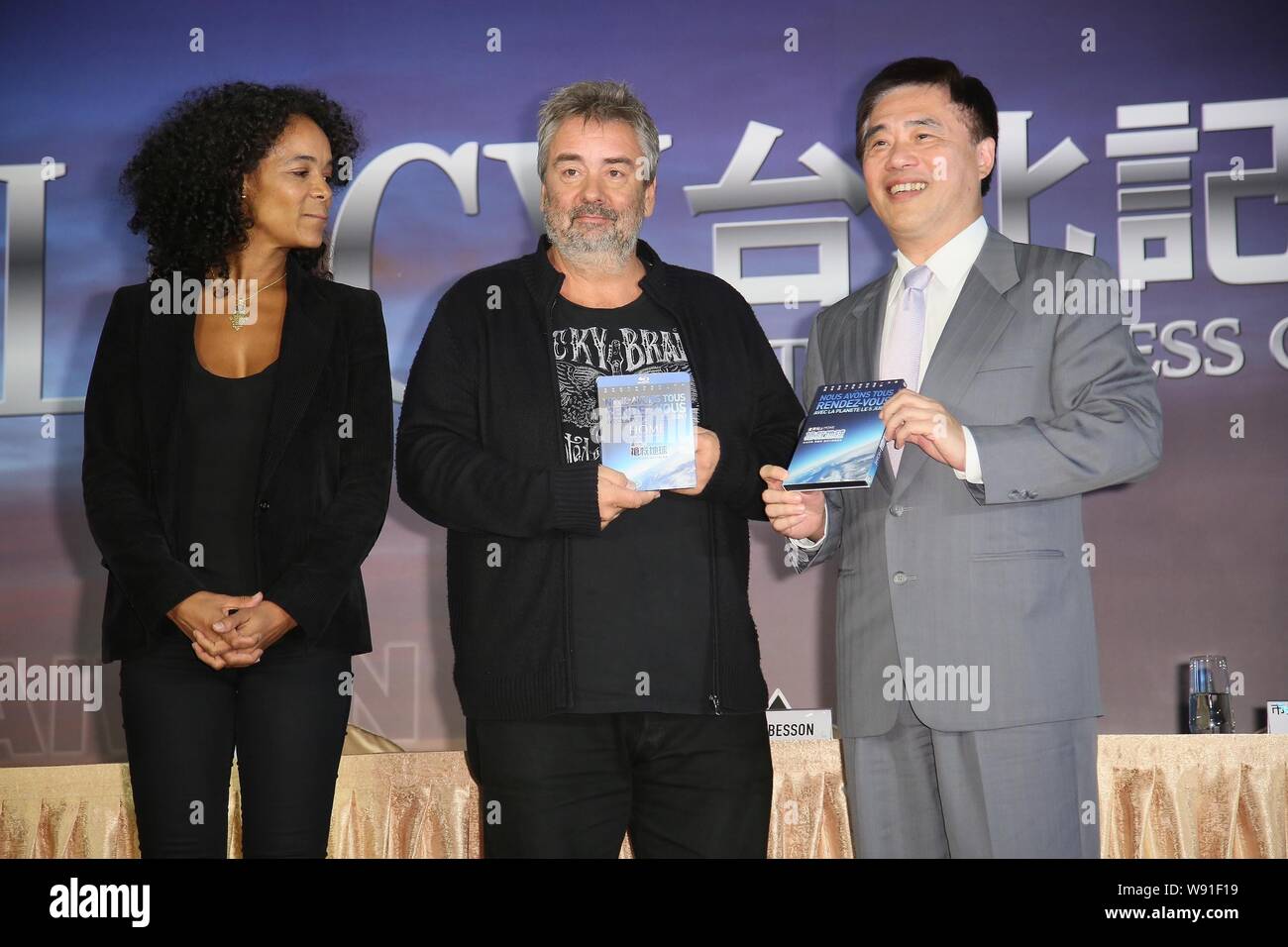 French director Luc Besson, center, poses with the DVD of his film ...