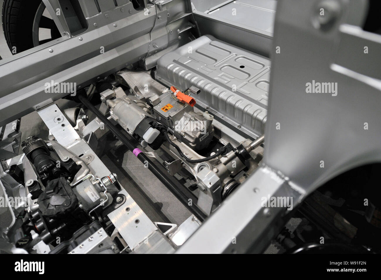Electrical devices are seen in a chassis of the Model S on display at ...