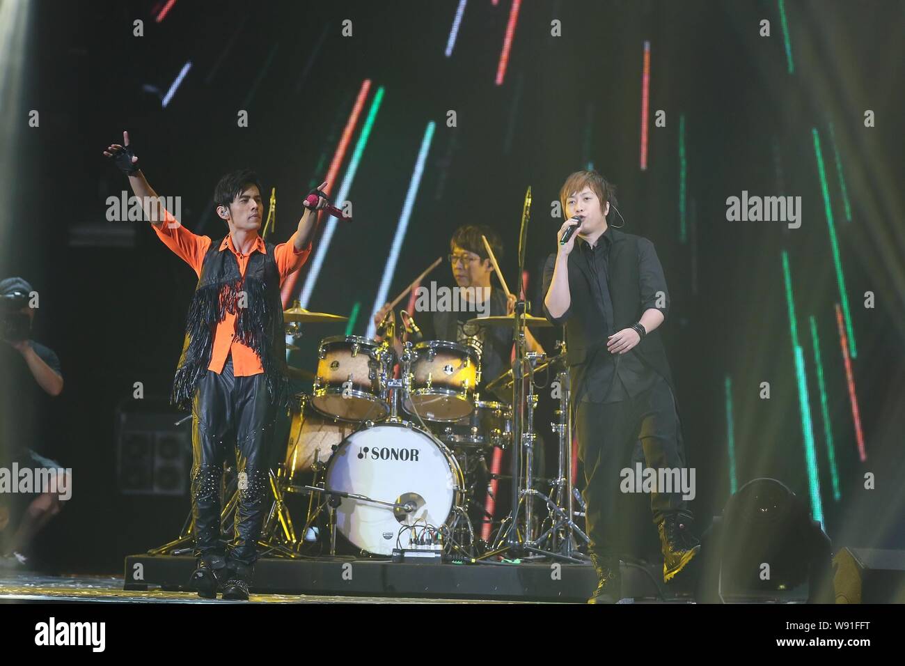 Taiwanese singer Jay Chou, left, performs with Taiwanese pop group May ...