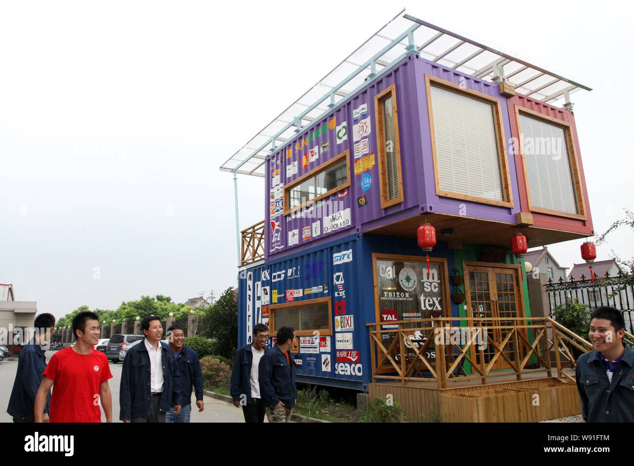 Local citizens visit the container house which is made from 4 ...