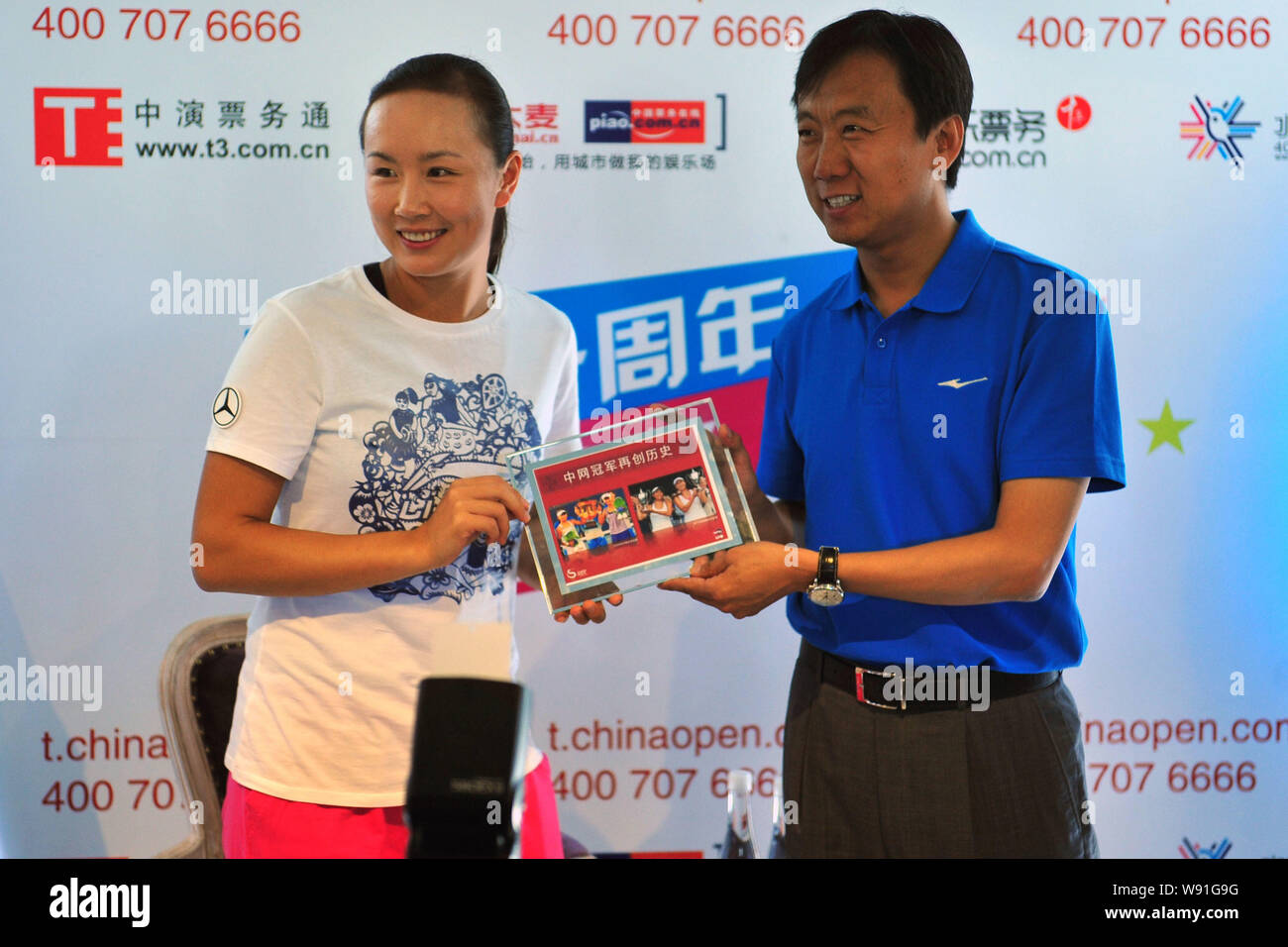 Chinese tennis player Peng Shuai, left, poses with a fan and his ...