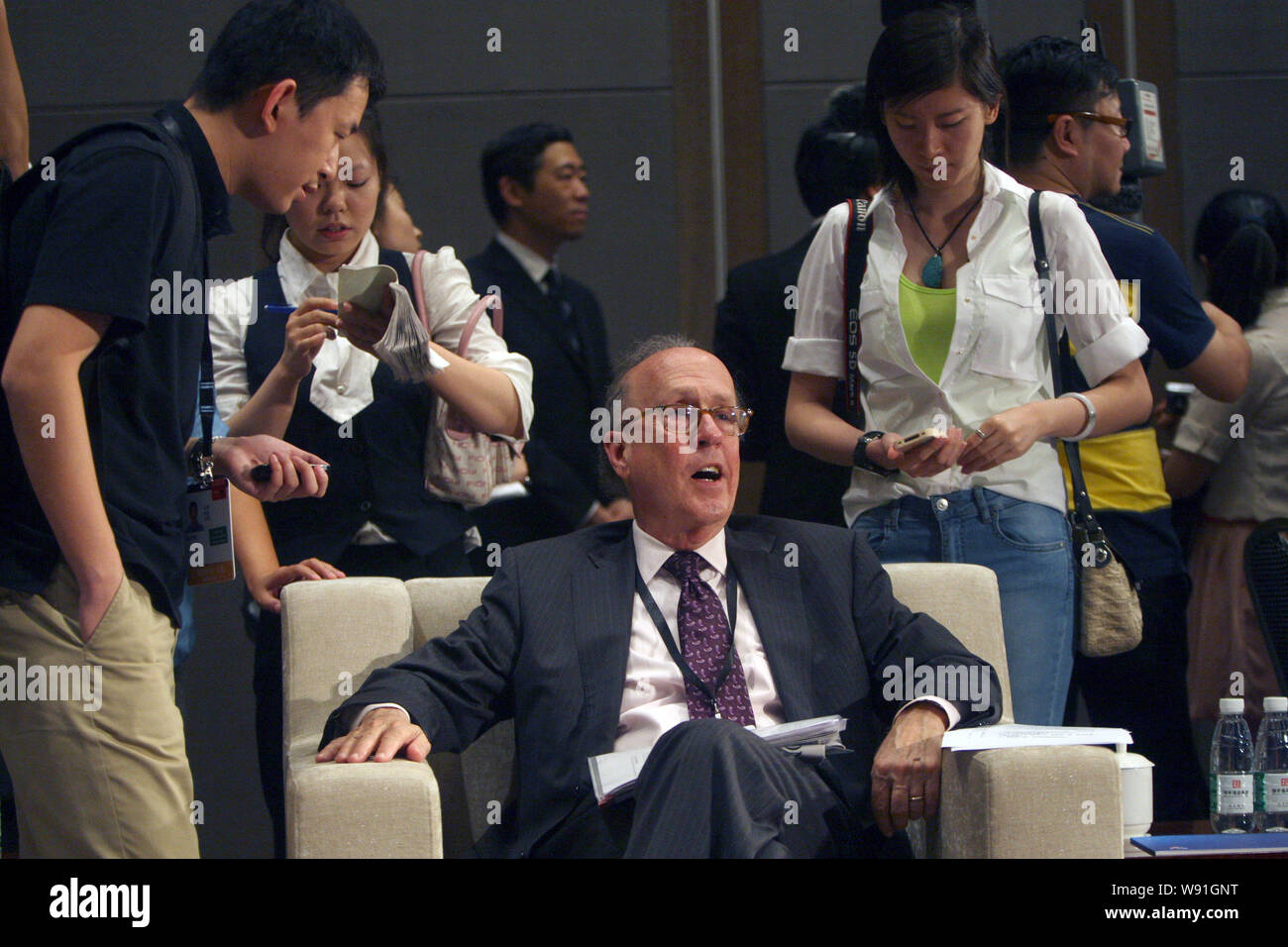 Professor Stephen S. Roach of Yale University, center, is interviewed ...