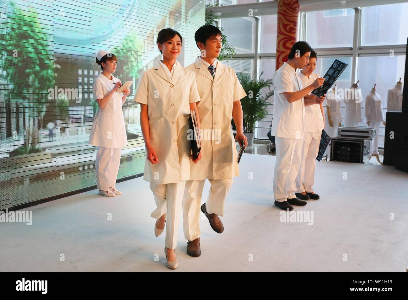 Chinese doctors and nurses display new hospital uniforms during a ...