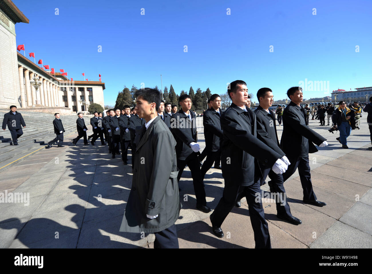 Chinese security guards patrol the square outside the Great Hall of the ...
