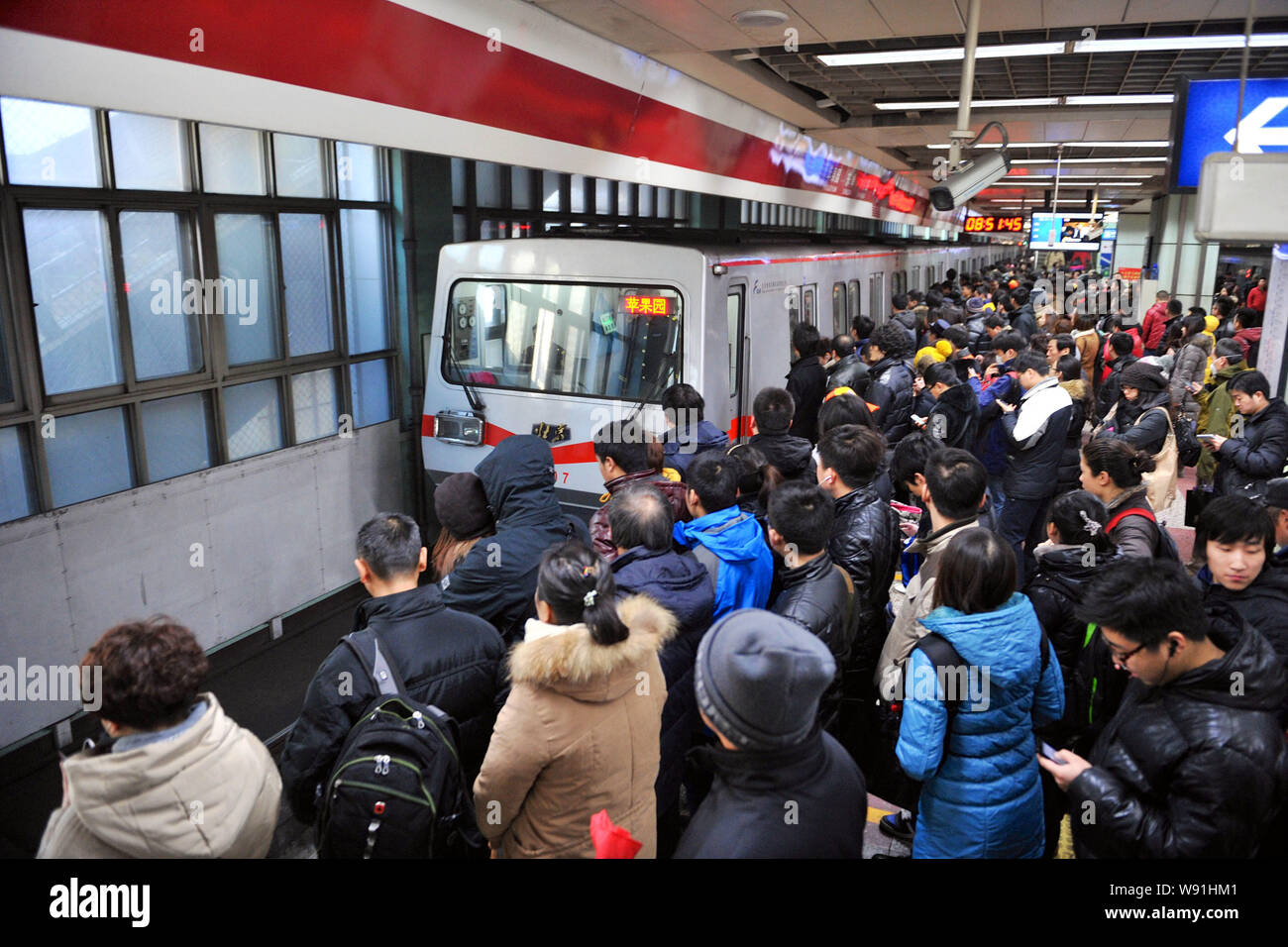 A crowd of passengers wait for a metro train at a subway station during ...